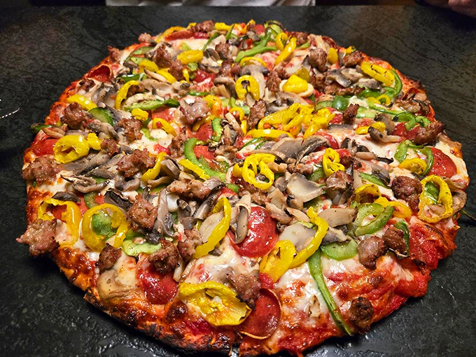 The Supreme Pizza showcases a colorful medley of toppings – proof that sometimes more really is more when it comes to pizza perfection.