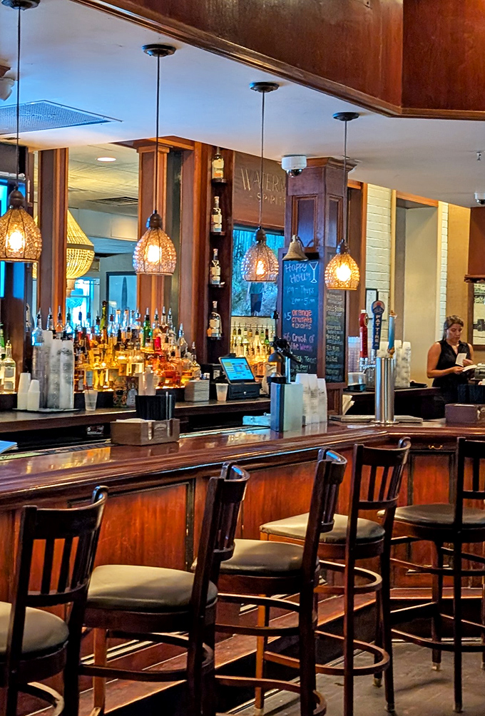 The bar at Waterman's glows with amber warmth, pendant lights casting a golden hue that makes everyone look like they're on vacation &ndash; even the locals.