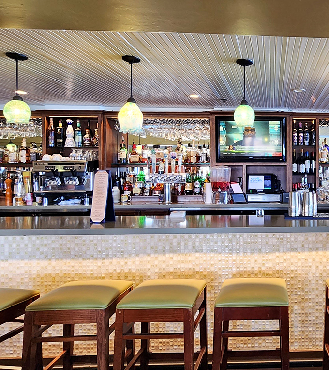 The bar doesn't just serve drinks; it offers front-row seats to the theater of mixology against a backdrop of coastal elegance.