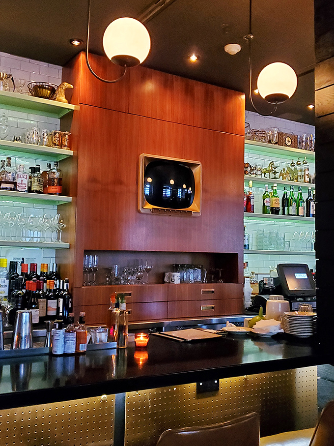 A bar that Don Draper would approve of, where the spirits are high and the lighting is perfectly calibrated for making memories.