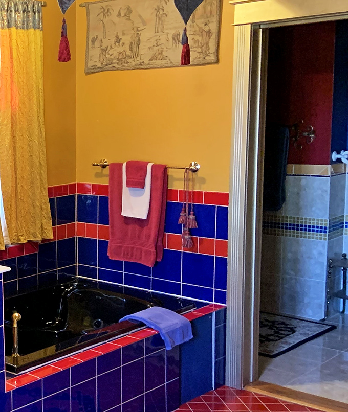 This bathroom's bold color scheme&mdash;royal blues and reds&mdash;transforms a functional space into something worthy of castle living.