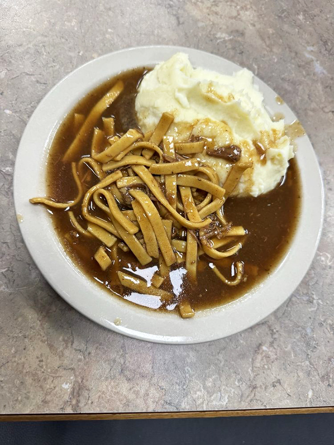 Homemade noodles swimming in rich broth alongside mashed potatoes—because in Ohio, one carb is never enough. Pure comfort in a bowl.