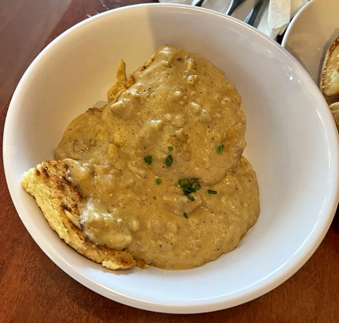 Southern comfort in a bowl: creamy biscuits and gravy with a sprinkle of chives&mdash;the kind of dish that makes you want to linger over coffee all morning.