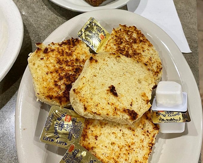 Golden-brown biscuits nestled in their basket like treasures, waiting to be slathered with butter and transformed into vehicles of joy.