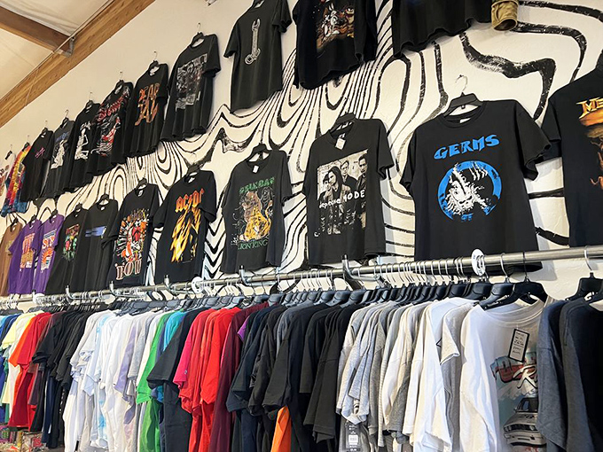 The band tee wall serves as a museum of musical history, where vintage concert shirts hang like rock and roll tapestries.