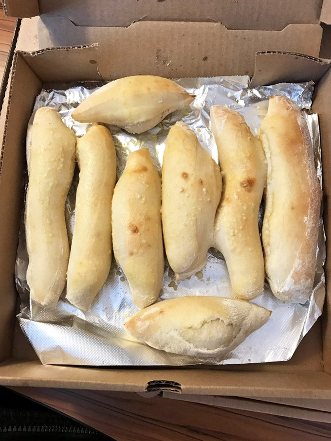 Breadsticks lined up like delicious soldiers ready for battle against your hunger. Simple, golden, and waiting to be dipped in something wonderful.