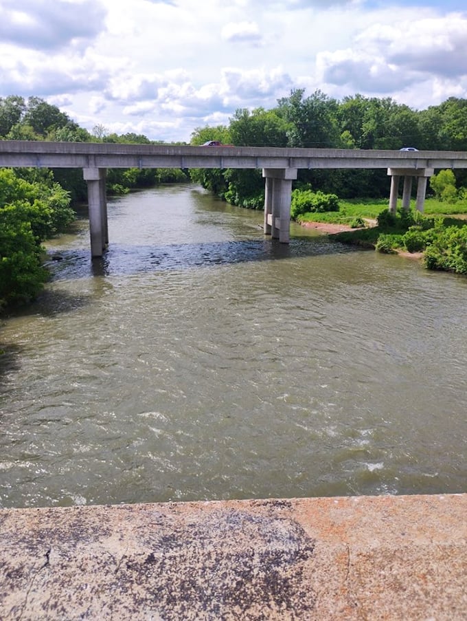 The bridge spanning Shoal Creek offers a different perspective of the waterway that feeds Grand Falls, connecting visitors to both sides of this natural wonder.