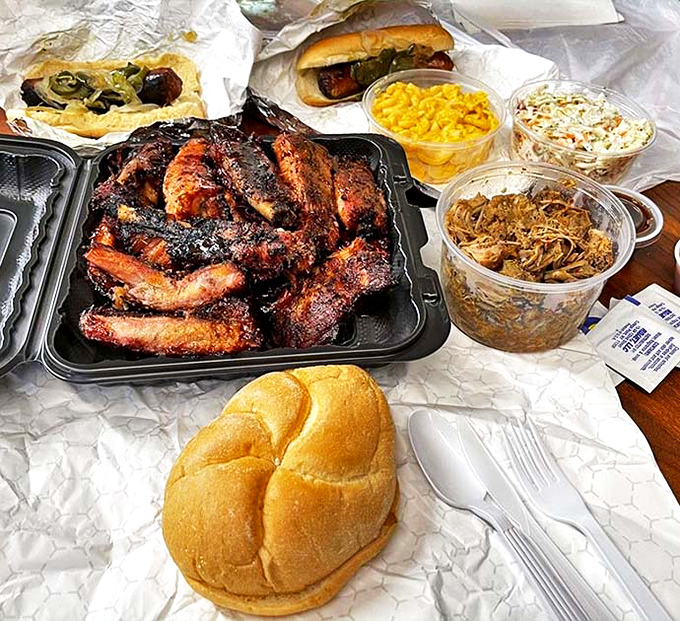 BBQ spread that would make a vegetarian question their life choices. The ribs take center stage, but those sides deserve their own standing ovation.