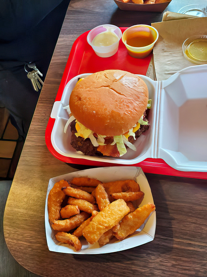 A proper burger with all the fixings, nestled in its foam throne. No pretentious stacking or architectural feats&mdash;just honest-to-goodness flavor.