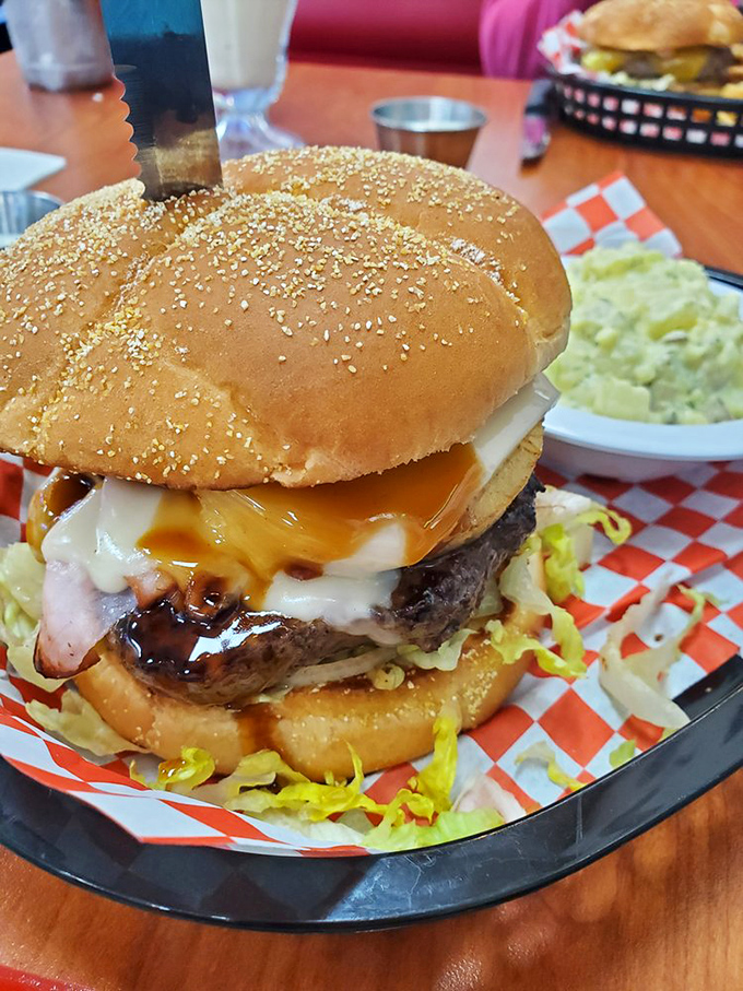 A burger so perfectly constructed it deserves its own blueprint. The melted cheese cascades down the sides like delicious lava from Mount Comfort Food.