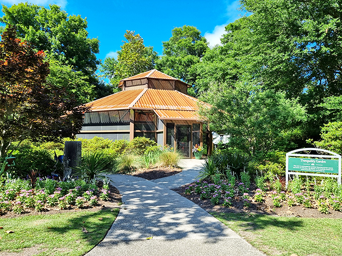 The butterfly house welcomes visitors with a copper roof gleaming in the sunshine, promising encounters with nature's most delicate aerial artists.