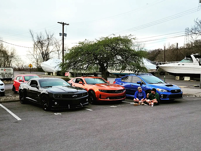 Car culture meets food culture in Jerry's parking lot, where muscle cars gather like hungry stallions waiting for their riders to bring back paper-wrapped treasures.