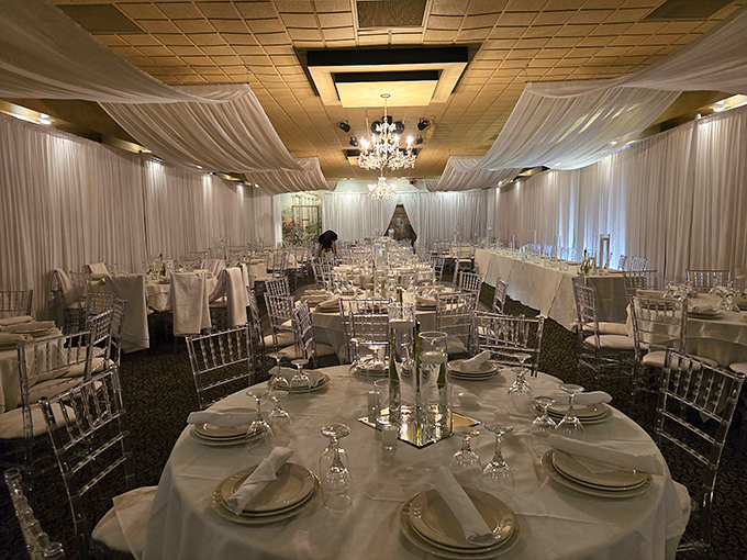 The elegant catering space draped in white transforms for weddings and celebrations, proving Angelo's handles special occasions with the same care as intimate dinners.