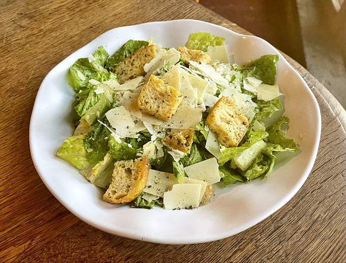 A Caesar salad that doesn't apologize for being simple. Crisp romaine, shaved parmesan, and croutons that actually taste like bread.