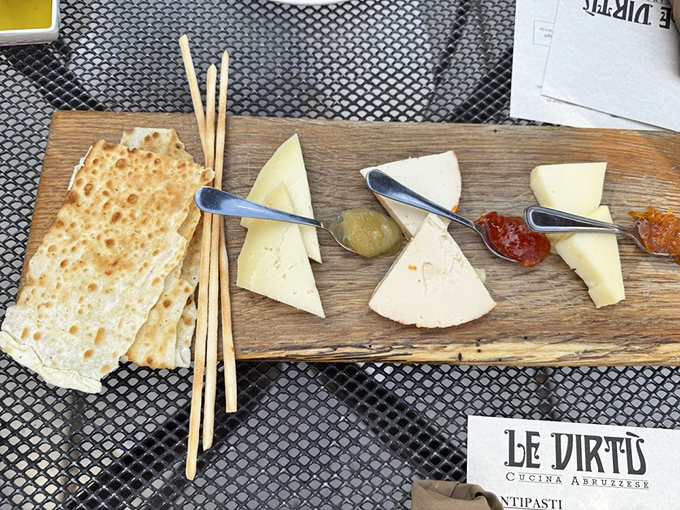 A cheese board that tells a story of tradition and terroir. Each wedge is a character in an Italian dairy drama, with breadsticks playing the supporting role.