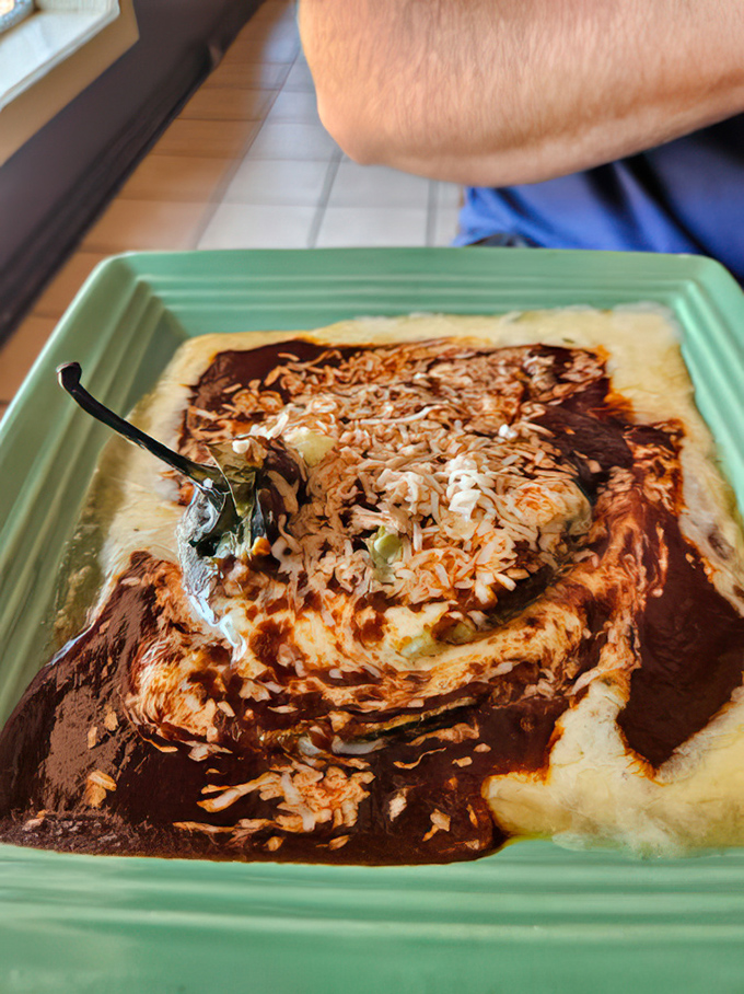 This chile relleno isn't just stuffed&mdash;it's having an identity crisis in the best way possible, swimming in a sauce worth bottling and taking home.