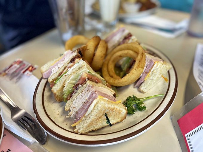 A club sandwich built like a skyscraper of flavor, with layers that work together in perfect harmony. Architecture you can eat.