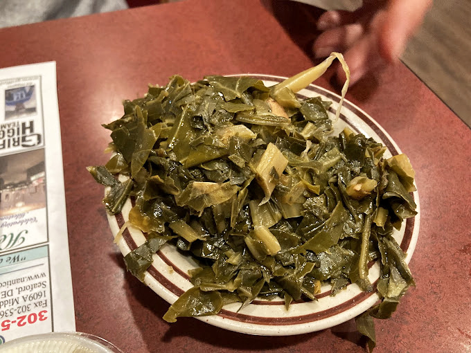 These collard greens have clearly been simmering since yesterday, soaking up flavors that can't be rushed or replicated in fancy kitchens.