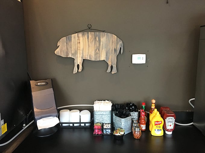 The condiment station&mdash;a barbecue United Nations where mustard, ketchup, and hot sauce coexist peacefully under the watchful eye of a wooden pig.