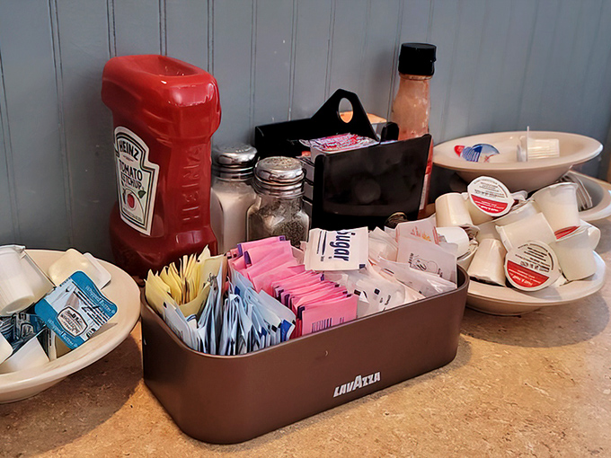 The condiment station: where breakfast dreams get their final flourish. That Heinz ketchup has seen things.