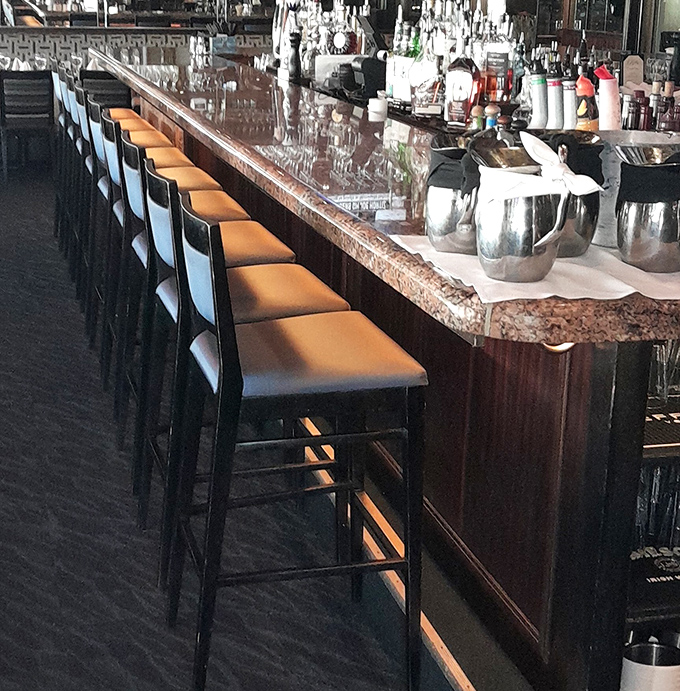 The counter seating offers front-row tickets to culinary theater, where every stool promises a different perspective on delicious drama.