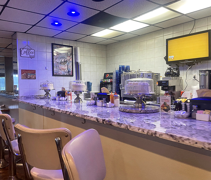 Counter seating where desserts tempt from glass cases and the rhythm of short-order cooking becomes a comforting soundtrack.
