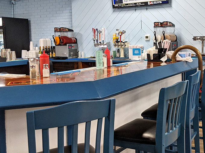 The blue counter with matching chairs invites solo diners to enjoy front-row seats to the breakfast theater, where coffee refills flow like conversation.