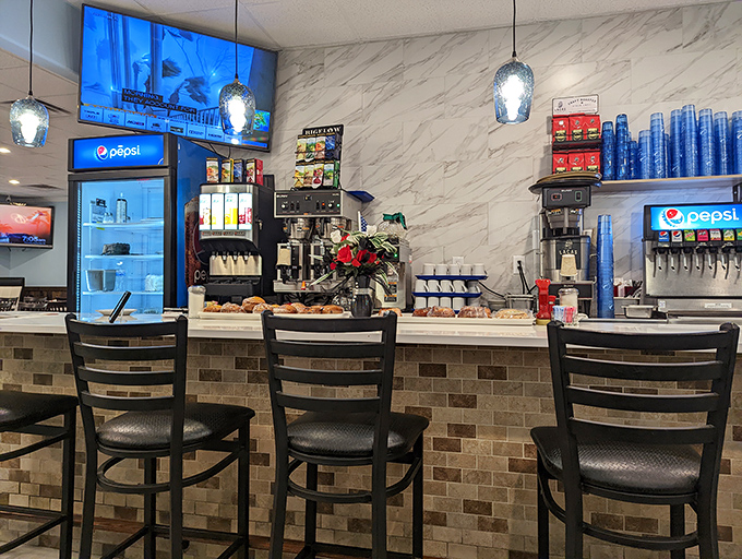 Counter seating where regulars perch like birds on a wire, watching the soda fountain ballet while trading neighborhood gossip.
