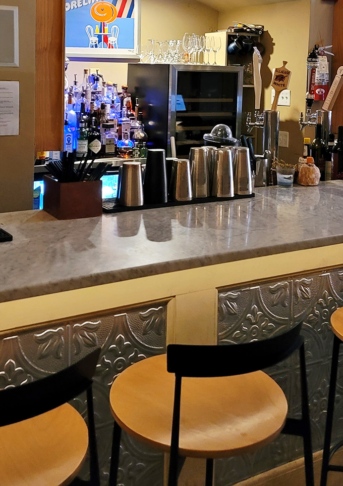 The bar area combines marble countertops with vintage-inspired tin details&mdash;like your stylish grandmother's kitchen got a modern upgrade.