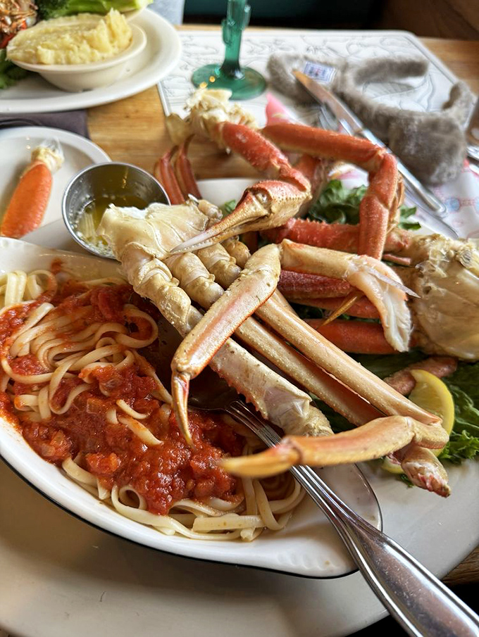 Snow crab legs with pasta—the surf and carb combo of your dreams. It's like the ocean and Italy decided to collaborate on your dinner.
