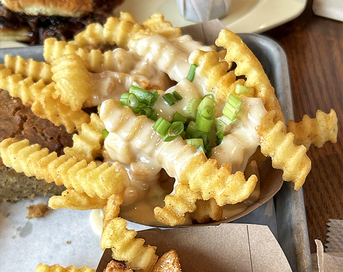 Crinkle-cut fries dressed up with cheese sauce and green onions. Proof that sometimes the best supporting actors steal the show entirely.