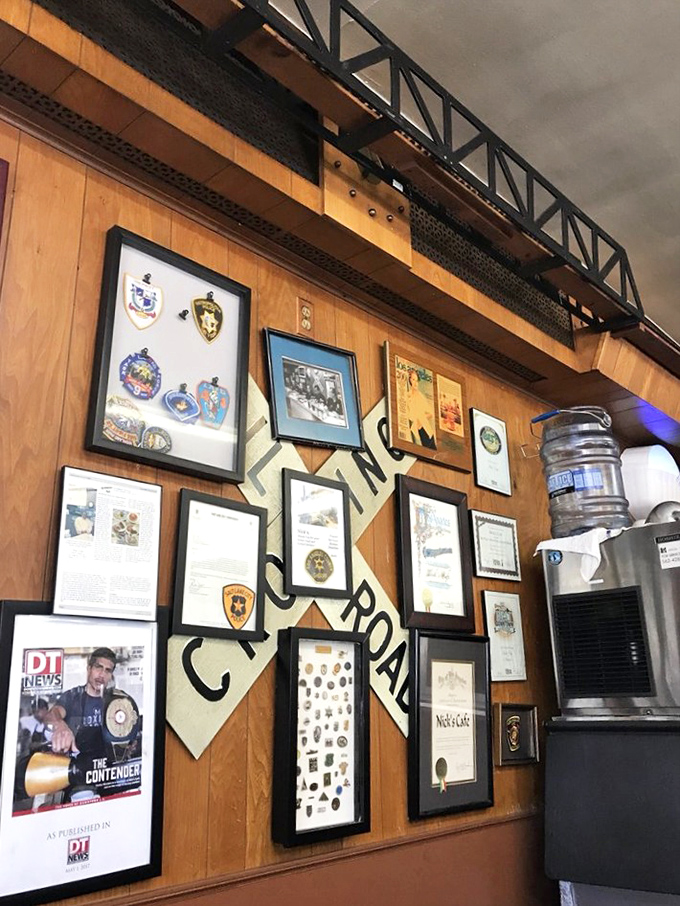 The wall of memories tells stories that menus can't. Each badge, photo, and clipping represents a chapter in the ongoing love story between Nick's and Los Angeles.