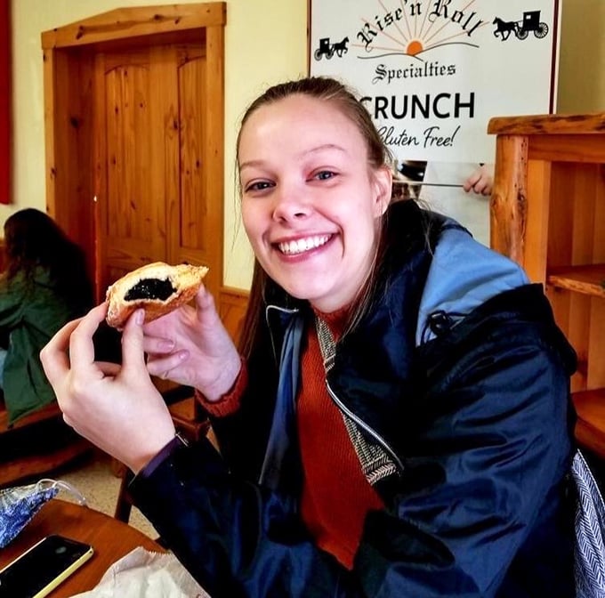 The sign behind this happy customer promises "CRUNCH" and her smile confirms that Rise'n Roll delivers on its gluten-free promises.