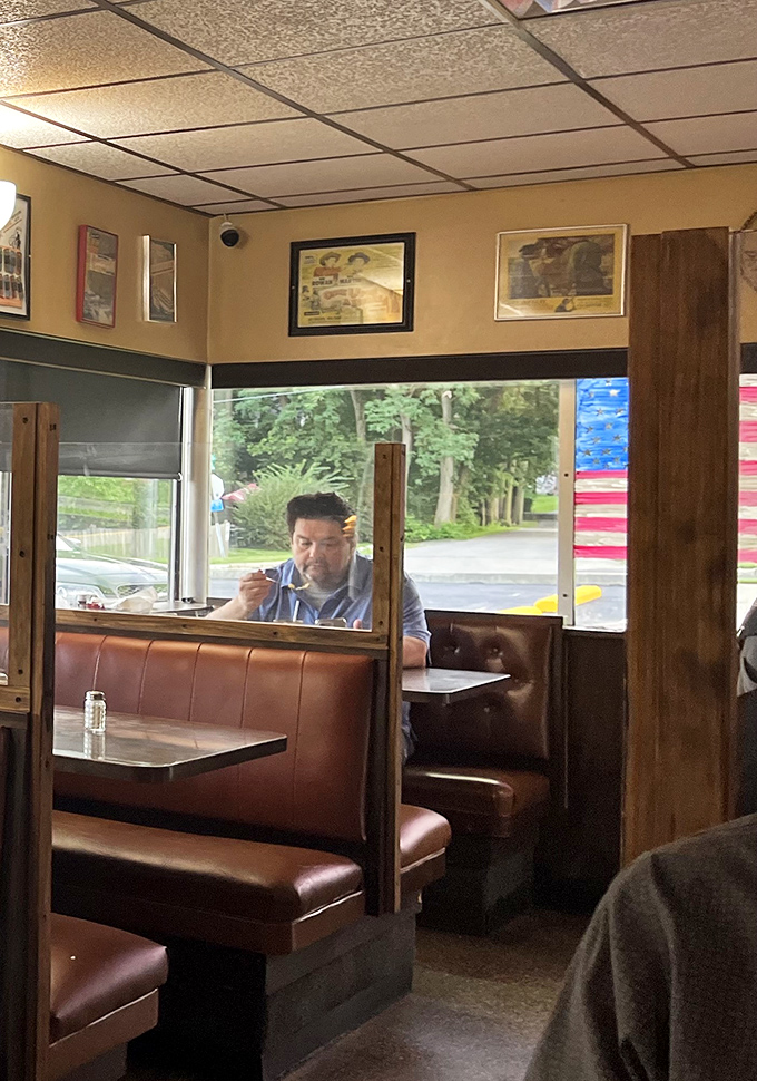 A lone diner enjoying his meal—part of the timeless ritual that makes places like this the backbone of American dining.