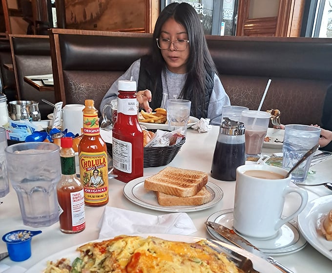 Breakfast spread that says "Good morning" better than words ever could. Hot sauce bottles standing like sentinels of flavor.