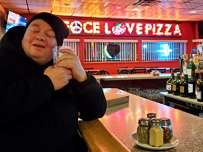 The bar area where strangers become friends and friends become family&mdash;all under the watchful glow of that iconic neon sign.