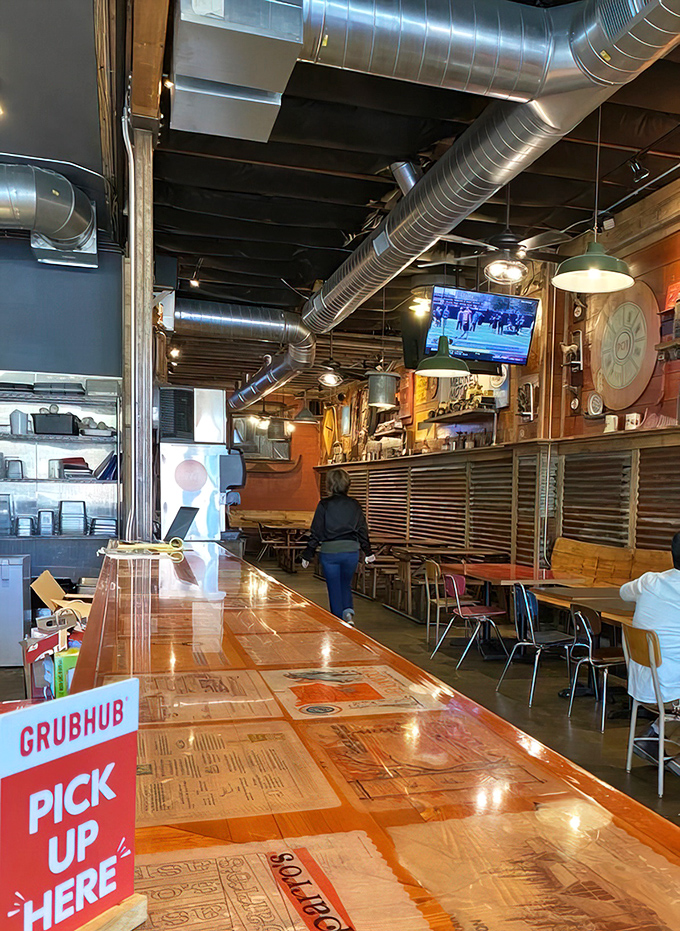 The long wooden counter isn't just functional&mdash;it's where chicken dreams come true. Note the Grubhub sign: civilization's gift to the hungry homebody.