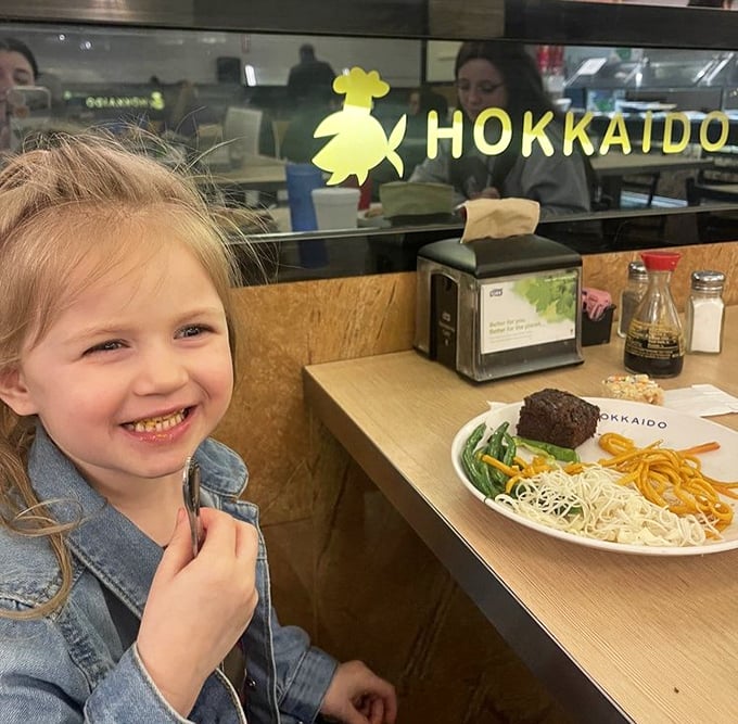 Even the youngest diners find joy at Hokkaido, where culinary adventures begin early. That smile says it all &ndash; future foodie in training.