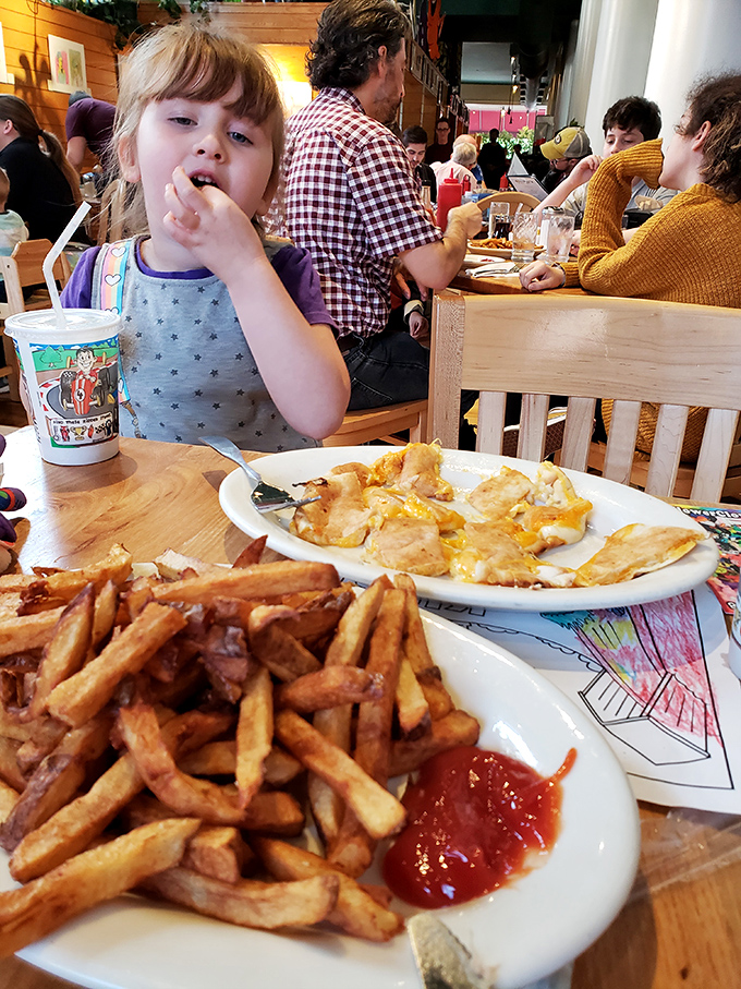 Family dining at its finest&mdash;where memories are made between bites of comfort food. That kid's face says it all: French fry happiness is universal.