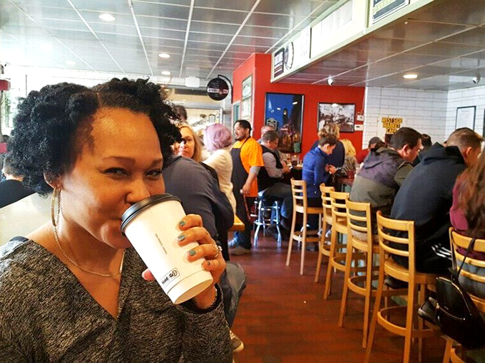 The caf&eacute;'s bustling interior where coffee fuels conversation and strangers become temporary neighbors in this Cleveland culinary community.