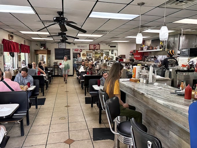 The bustling heart of Osteen Diner, where coffee flows freely and the counter seats offer front-row views to short-order magic.