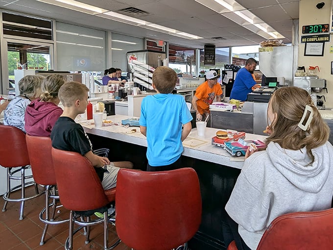 Counter culture at its finest&mdash;kids perched on red stools, watching culinary theater unfold. This is childhood memory-making in real time.