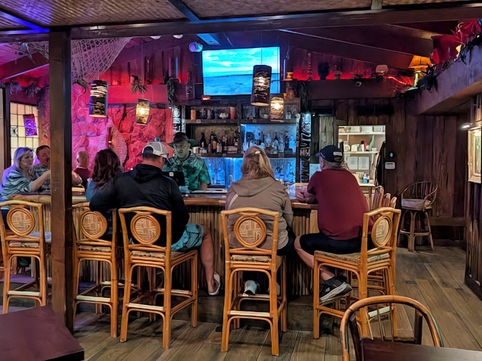 Authentic bamboo bar stools and atmospheric lighting create the perfect setting for intimate tropical cocktail conversations.
