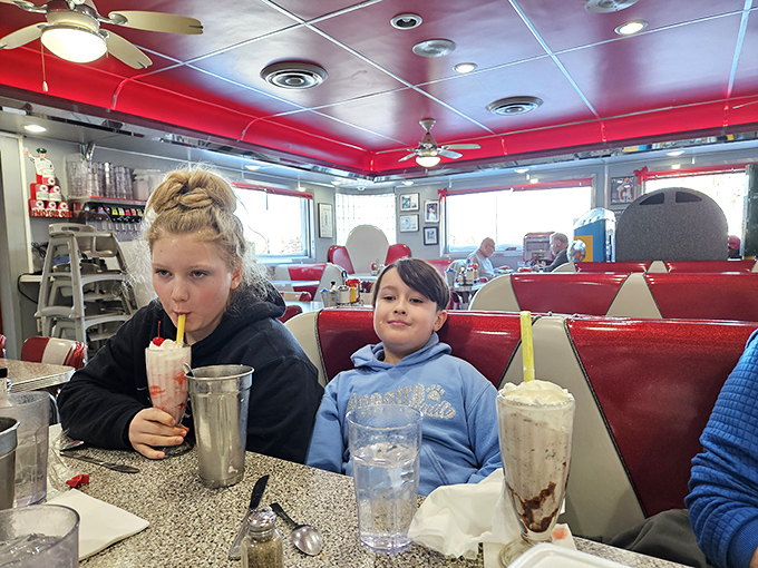 Milkshakes so thick they require serious straw skills &ndash; these young diners are up for the challenge in Gus's classic red and white booths.