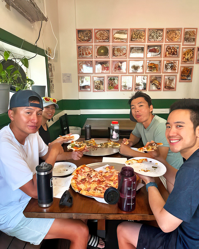 Good food brings people together. These diners aren't just eating pizza&mdash;they're creating memories around a table that transcends the ordinary meal.