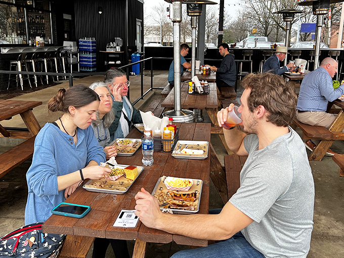 The outdoor dining area brings together locals and visitors alike, united by the universal language of "mmm" and "pass the sauce."