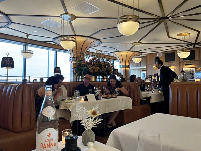The dining room hums with conversation and clinking glasses, while those curved leather booths cradle diners like a warm Italian grandmother's hug.