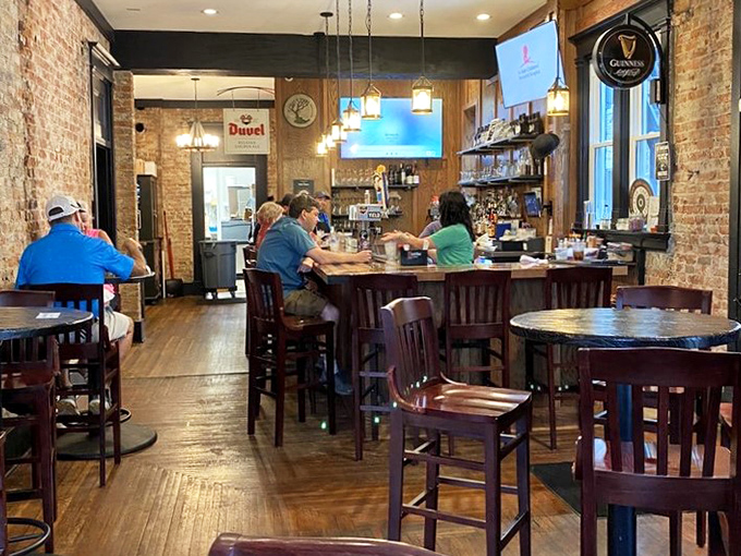 The bar area buzzes with conversation and community. Those wooden chairs have supported more great stories and laughter than most therapists.