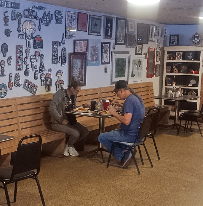 The art-covered walls create the perfect backdrop for what truly matters: strangers becoming friends over plates of comfort food.