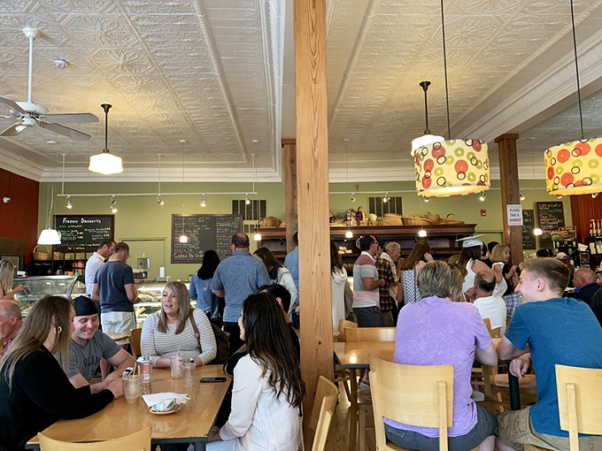 The bustling dining area hums with conversation and the occasional gasp of pastry-induced delight. Community happens over cannoli and cappuccino.